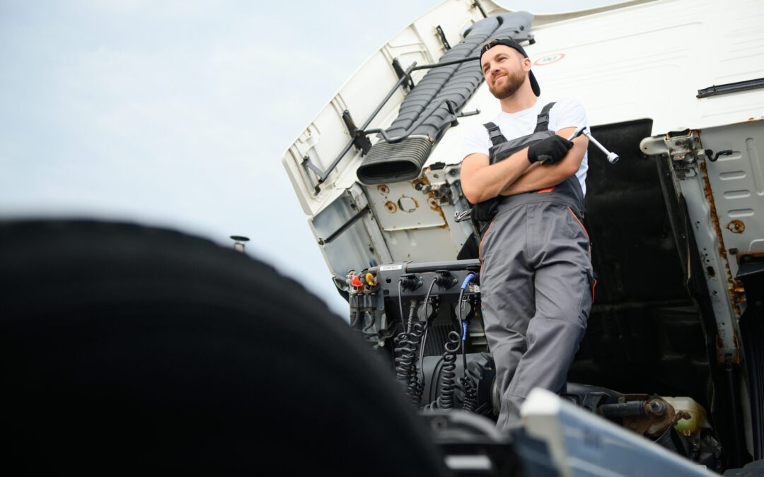 Semi Truck Under Maintenance. Caucasian Truck Mechanic Working to Fix ...